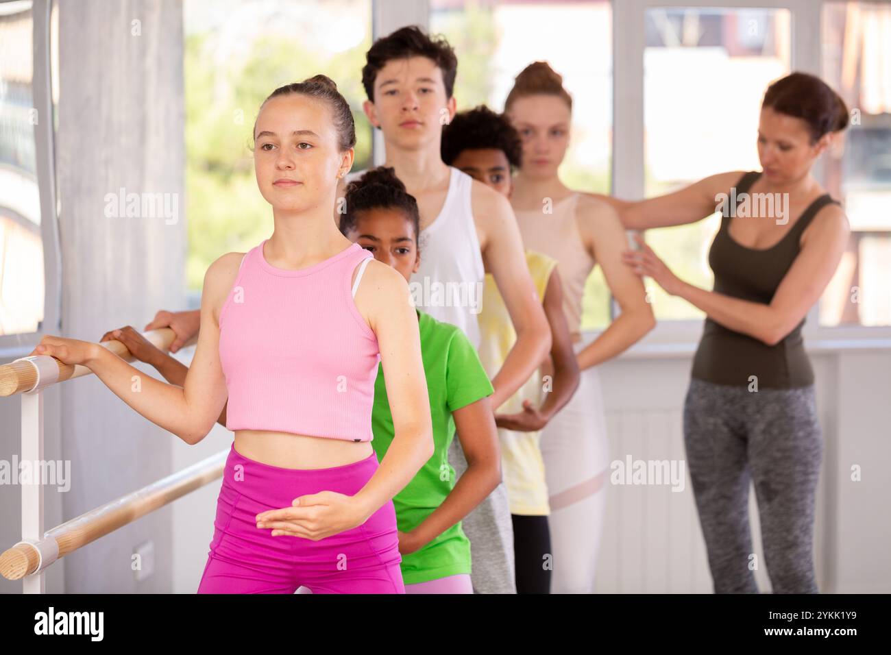 Teenage girl practicing ballet positions in dance studio Stock Photo ...