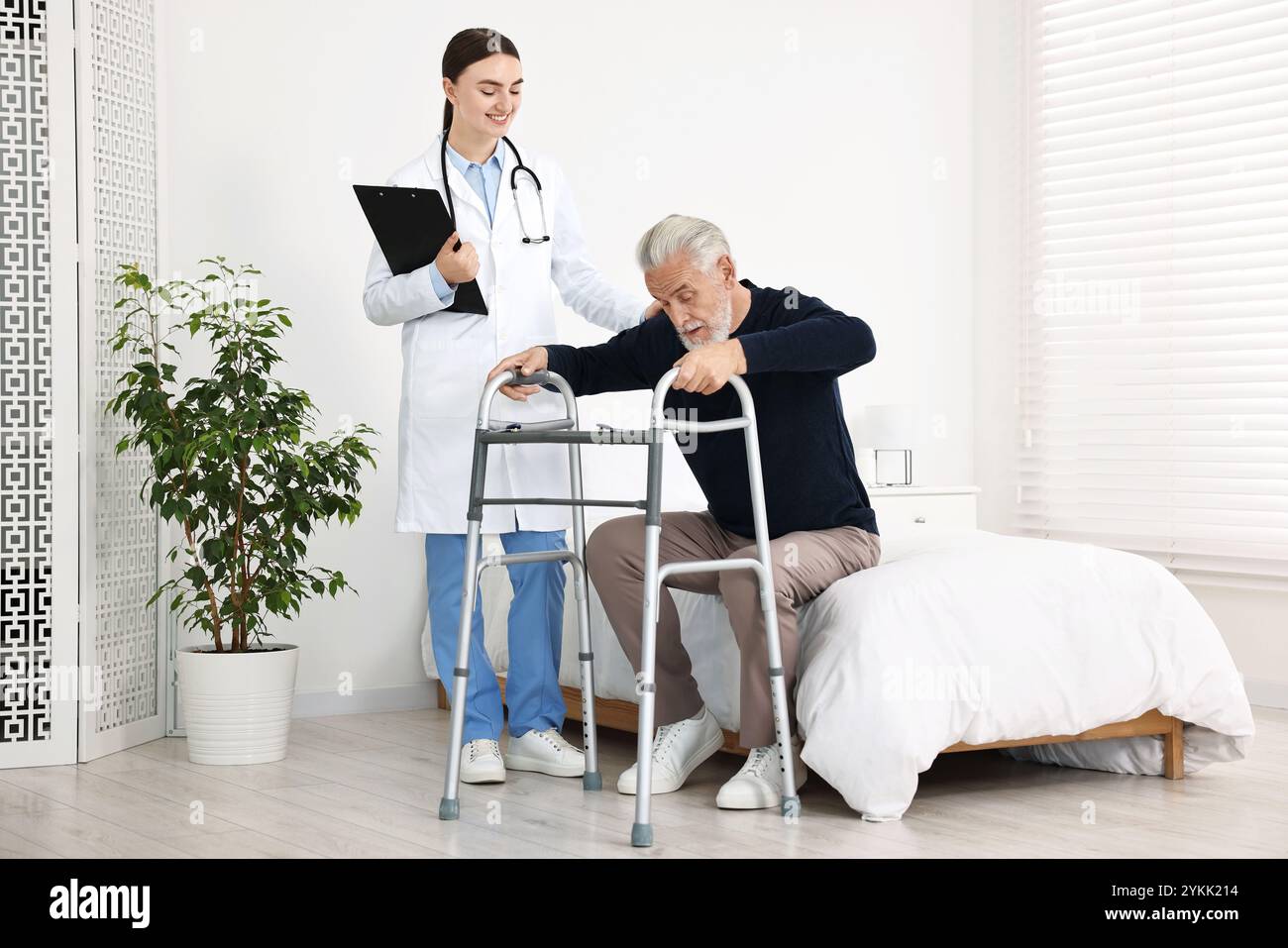 Doctor helping young man rehabilitation hi-res stock photography and ...