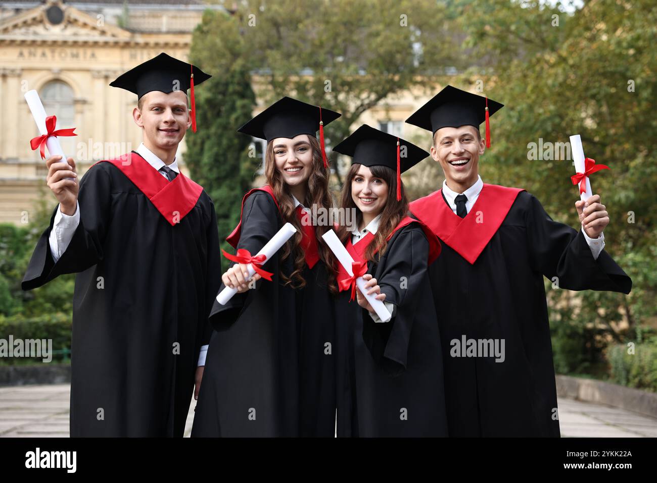 Happy students with diplomas after graduation ceremony outdoors Stock ...