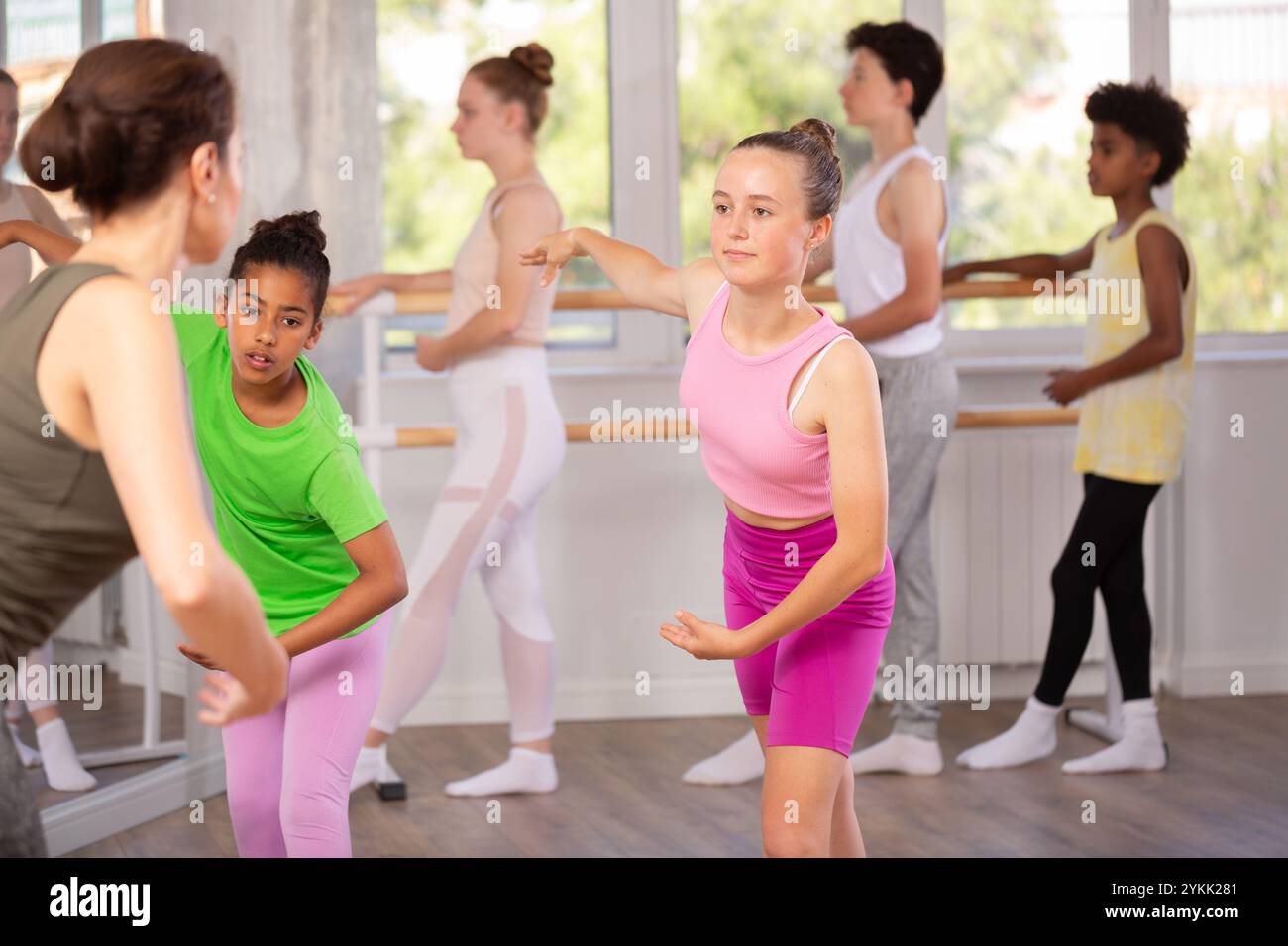 Teen girl practicing ballet movements at group class Stock Photo - Alamy