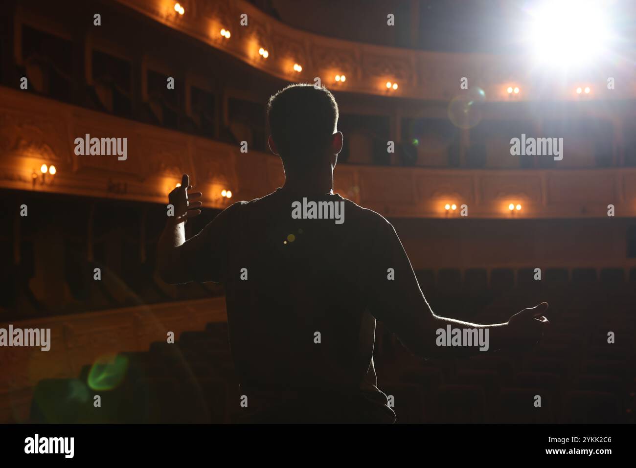 Professional actor rehearsing on stage in theatre, back view Stock ...
