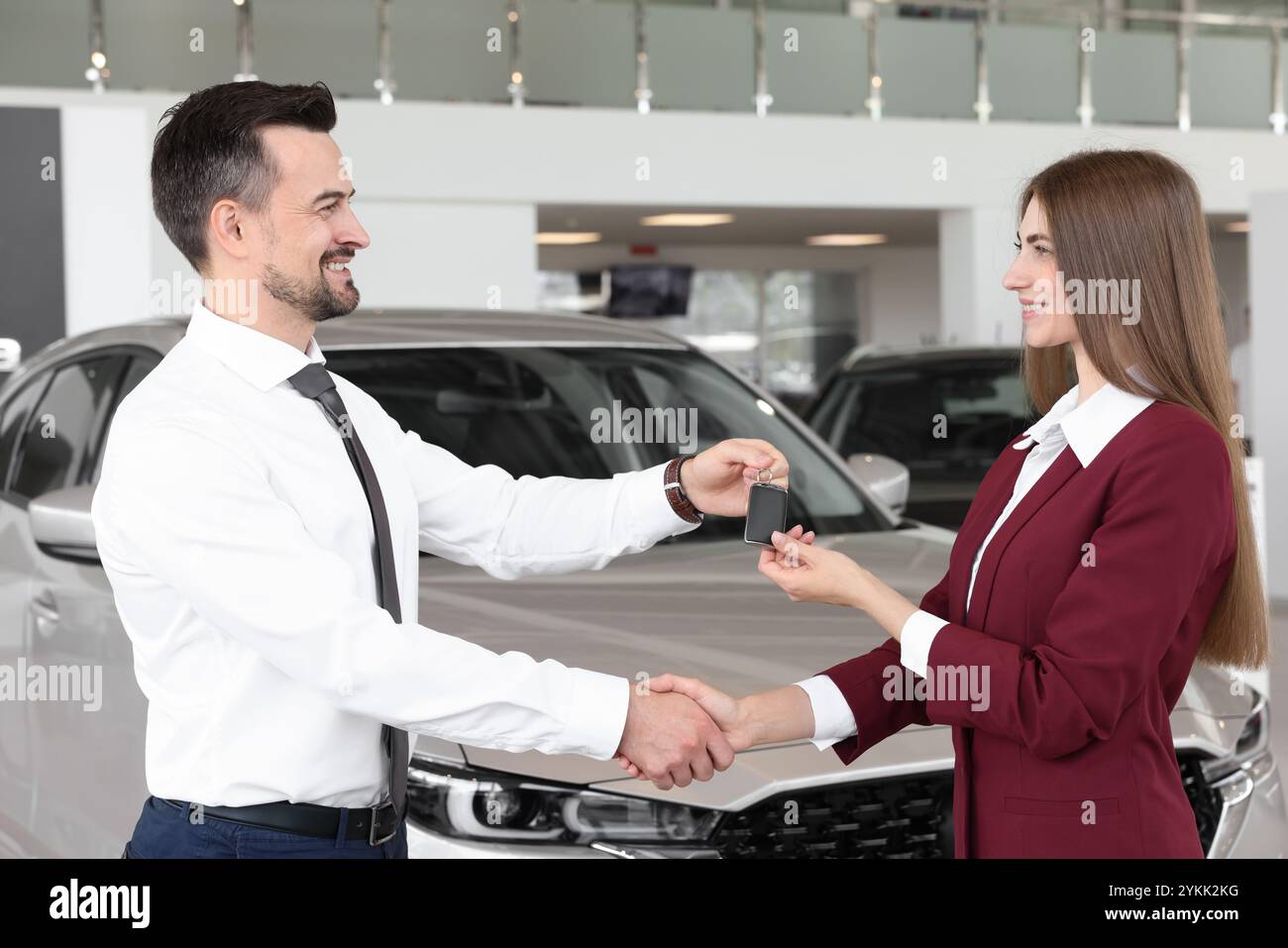 Salesman giving handshake male female hi-res stock photography and ...