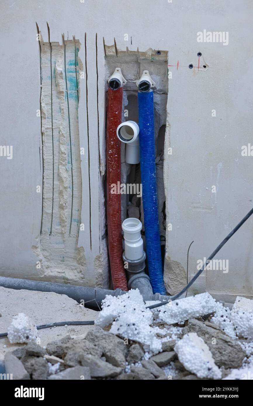 Plumbing installation in progress with red and blue water pipes ...