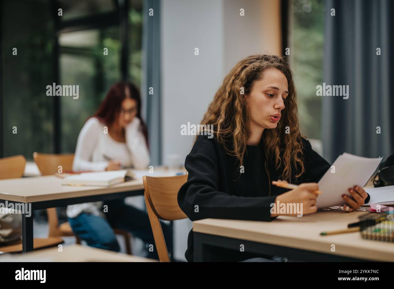 Focused students studying in a modern classroom environment Stock Photo ...