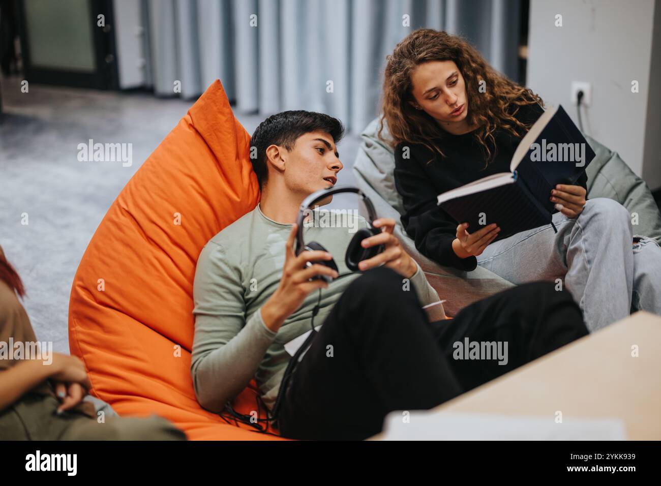 High school students relaxing while studying together inside a ...