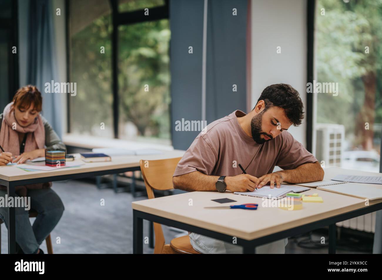 Students focused on studying in a modern classroom setting Stock Photo ...