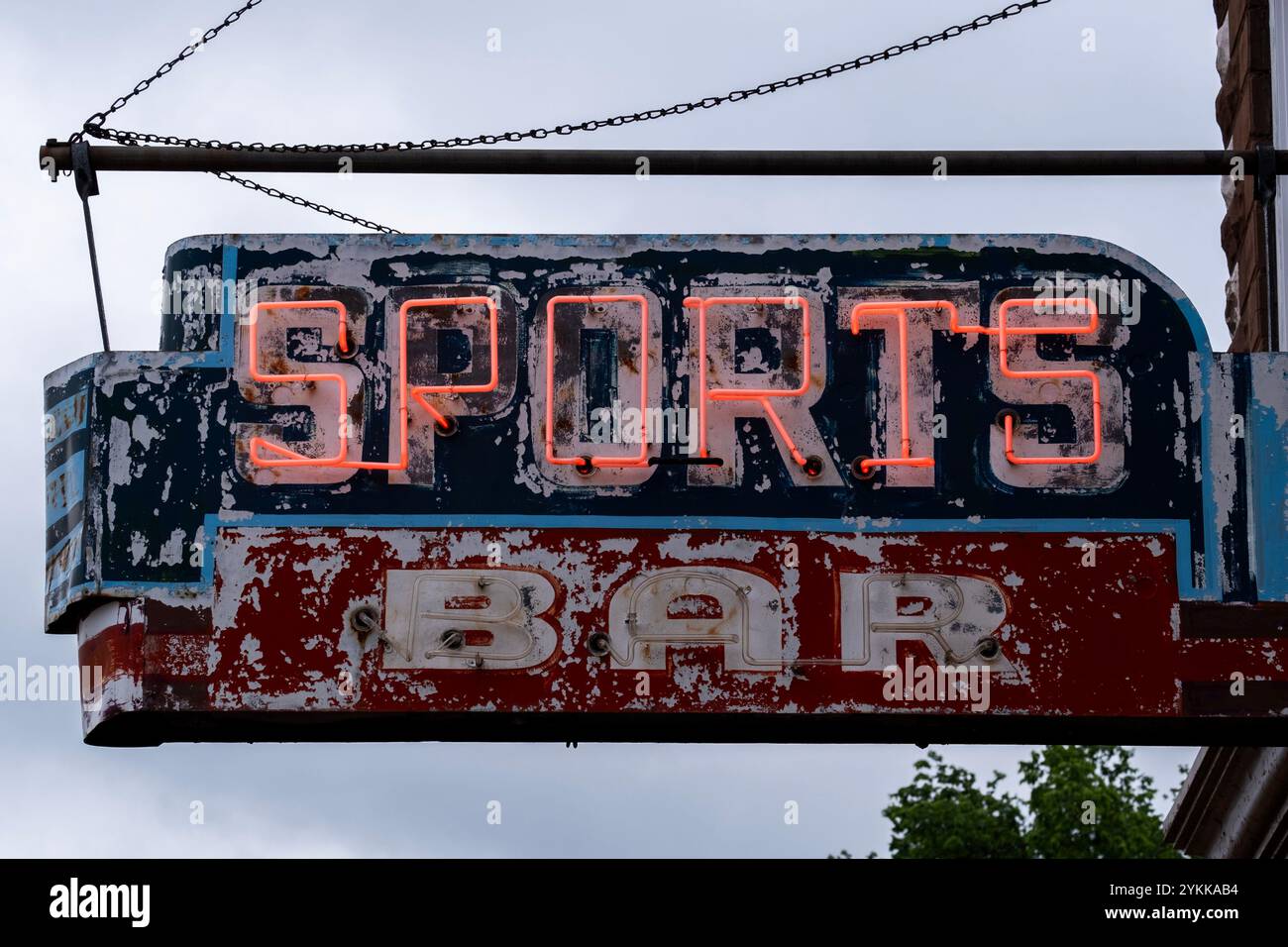 Old weathered neon sign reading Sports Bar with peeling paint on an old ...