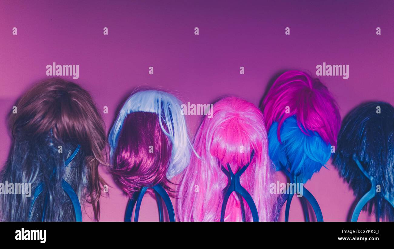 Colorful Fashion Costume Wigs on Mannequin Heads and Pink Background ...