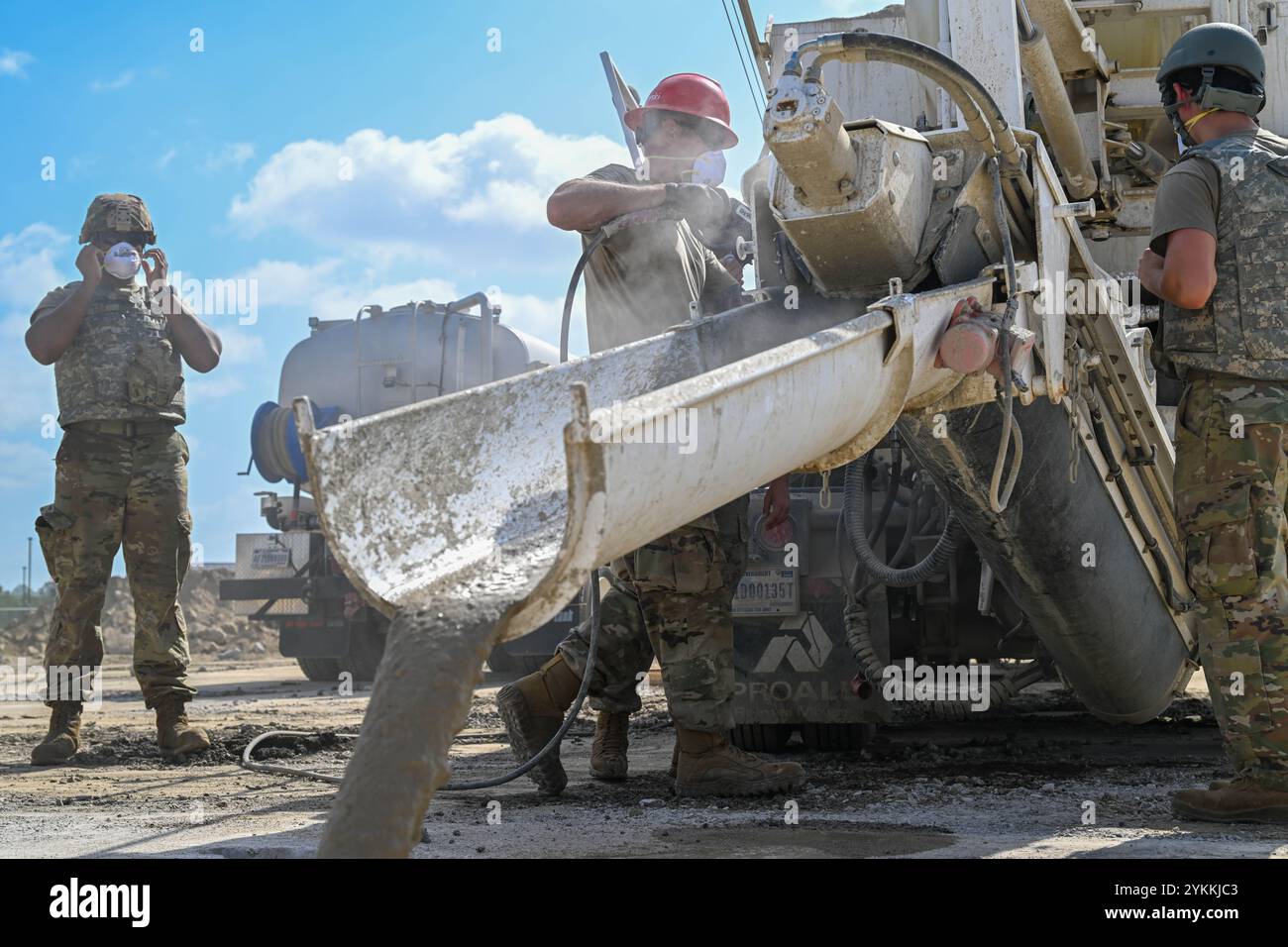 U.S. Airmen assigned to the 509th Civil Engineer Squadron pour concrete ...