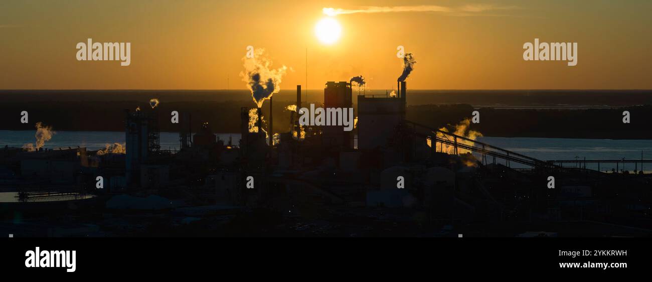 Aerial view of large factory with smokestack from production process ...