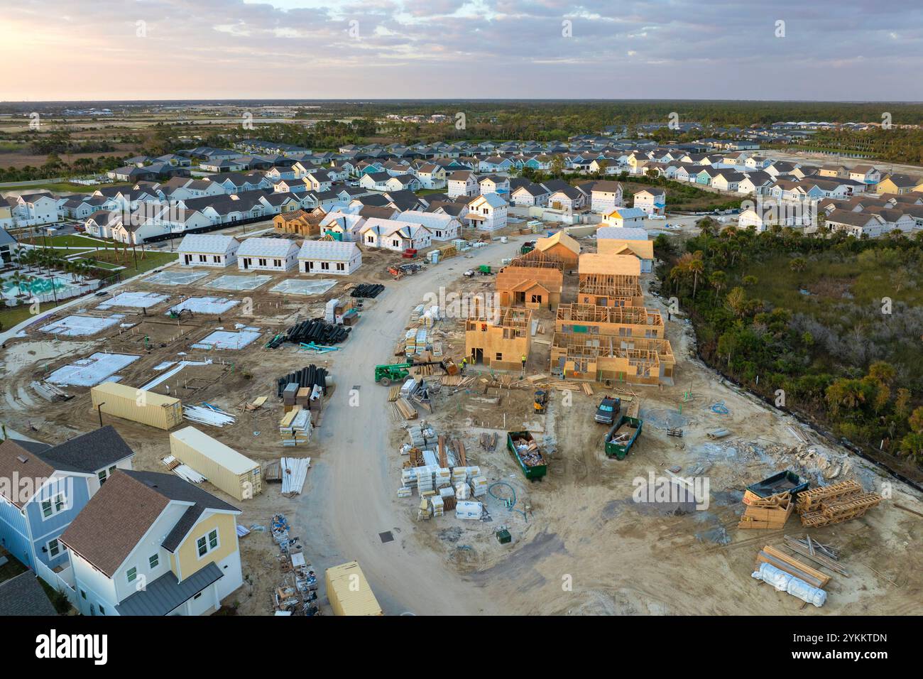 Aerial view of unfinished wooden frames of affordable houses under ...