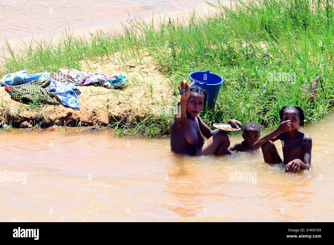 Bathing in a muddy river in the Central Highlands in Madagascar Stock ...
