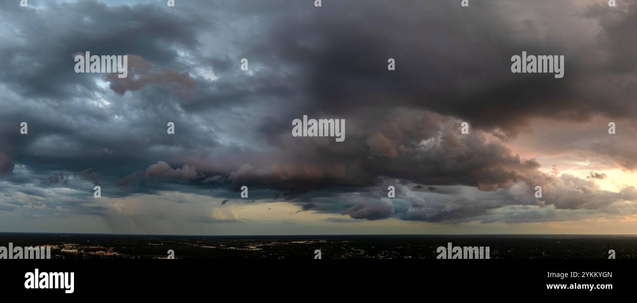 Heavy rain falling down from stormy clouds during thunderstorm on dark ...