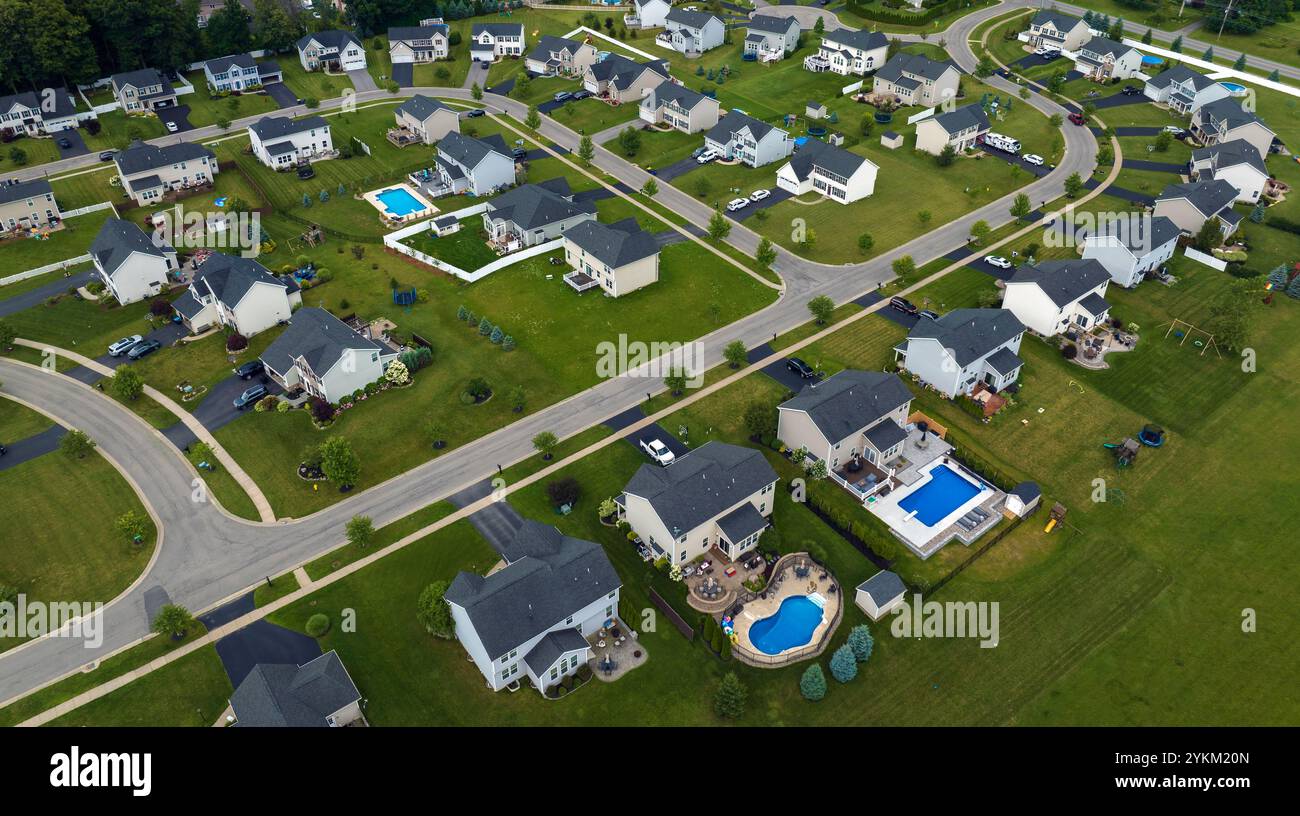 Upscale suburban homes with large backyards and green grassy lawns in ...