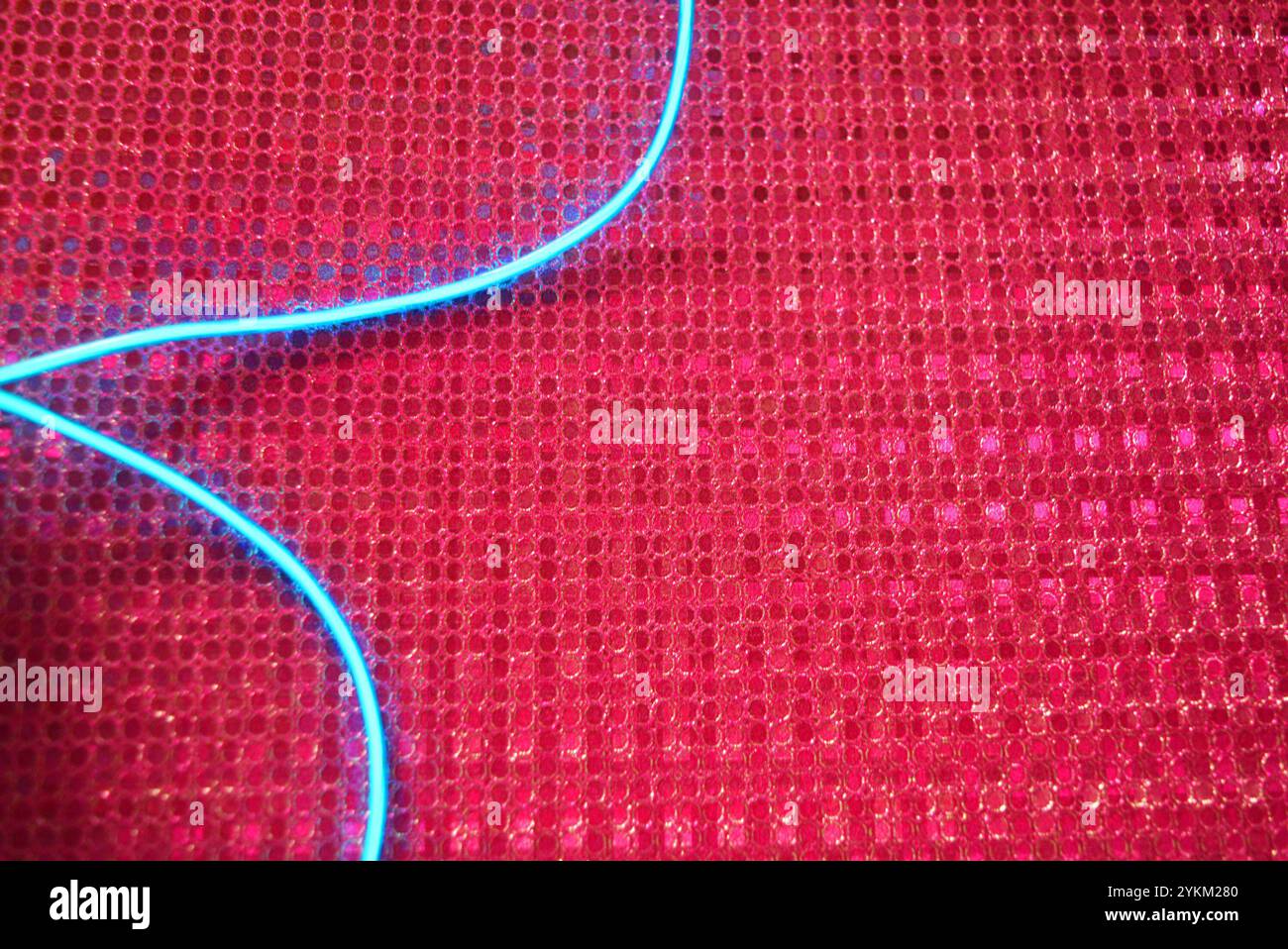 An unusual glowing, electroluminescent blue wire is located on a bright ...