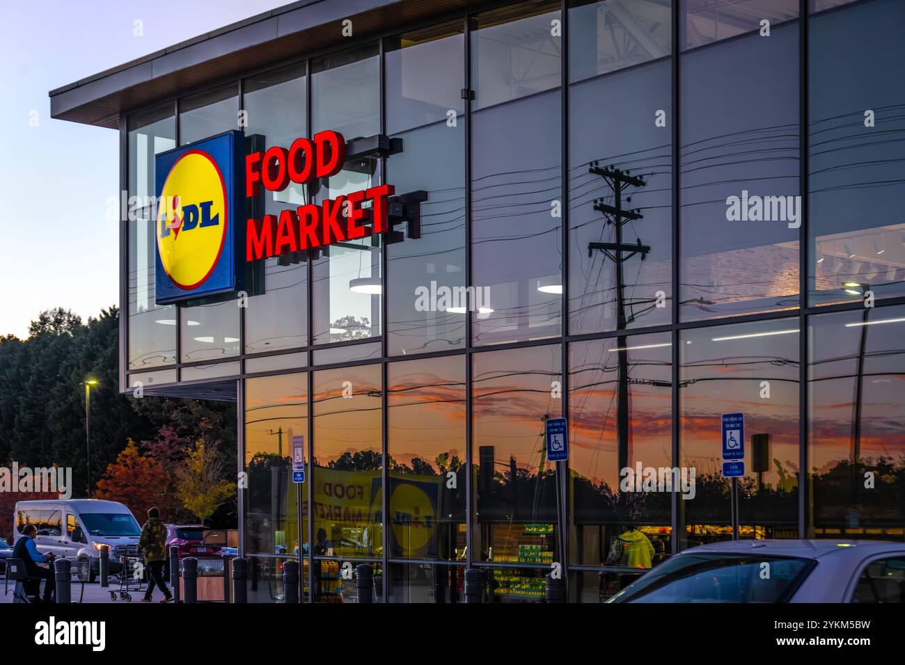 Shoppers at Lidl Food Market on a colorful autumn evening in Metro ...