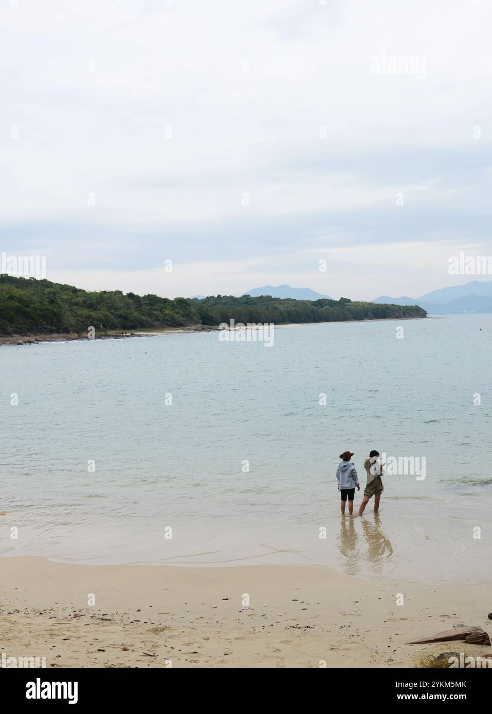 Tourist walking on the sandy beach in the eastern part of Tung Ping ...