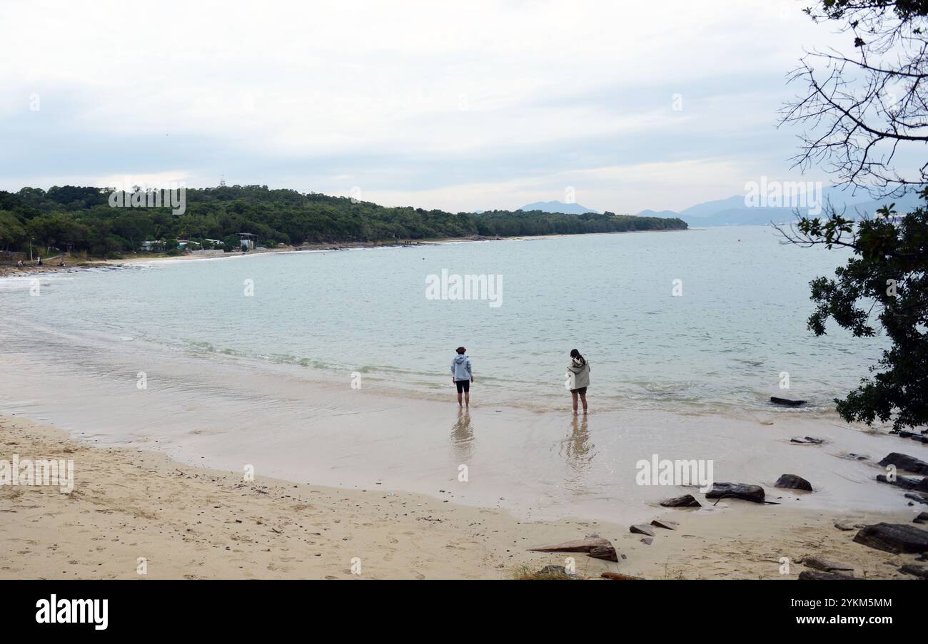 Tourist walking on the sandy beach in the eastern part of Tung Ping ...