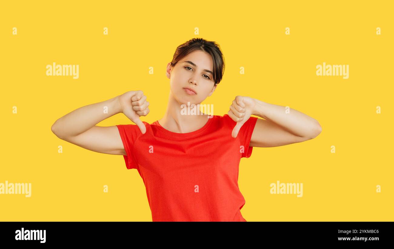 Dislike gesture. Disappointed woman in red expressing dissatisfaction ...