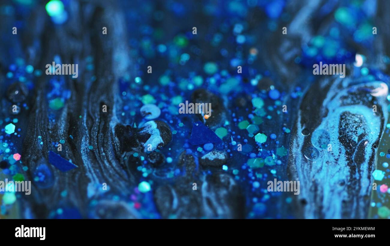 Acrylic paint mix. Wet glitter spill. Defocused blue black color ...
