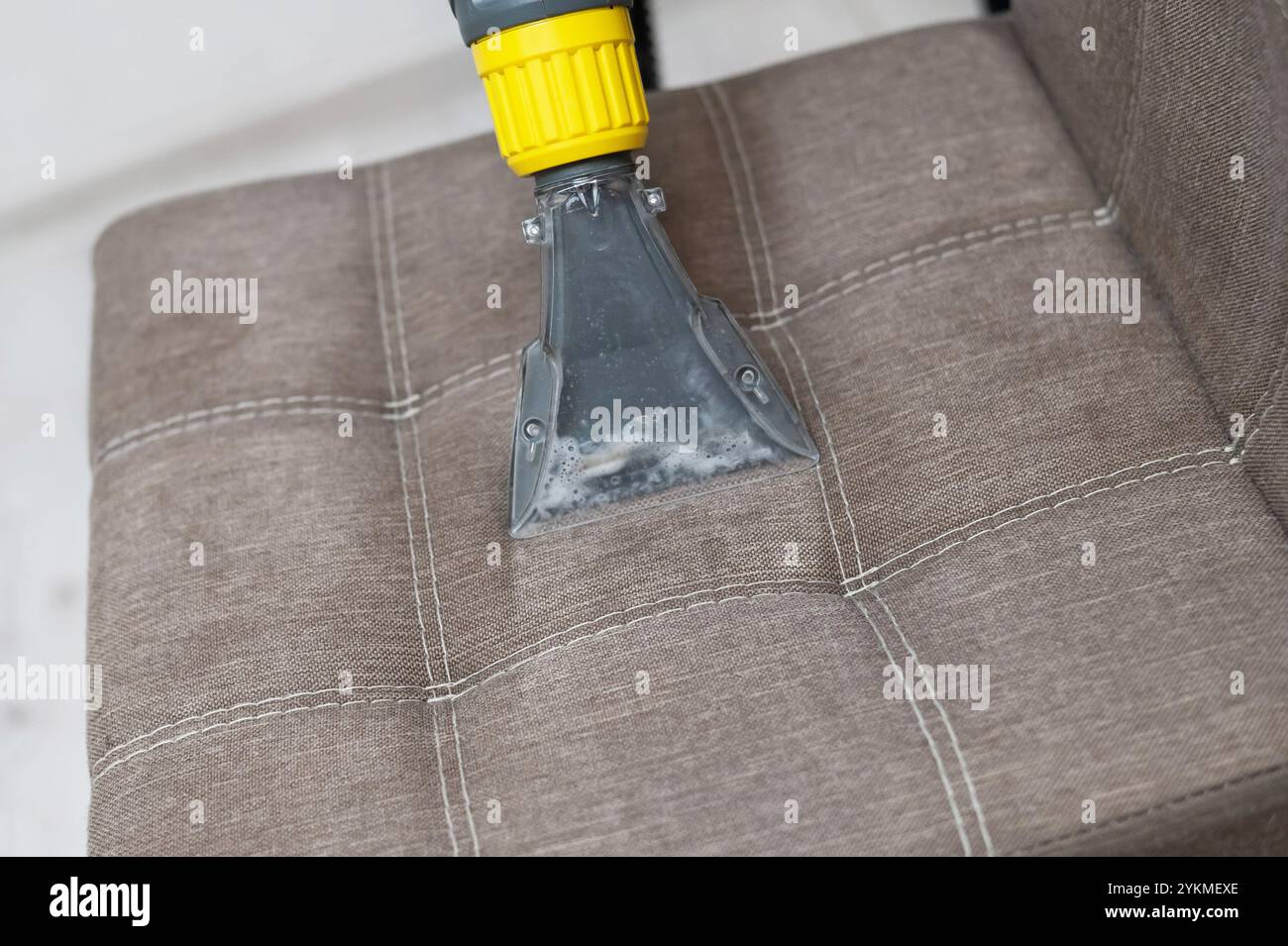Dry cleaning a fabric chair Stock Photo - Alamy