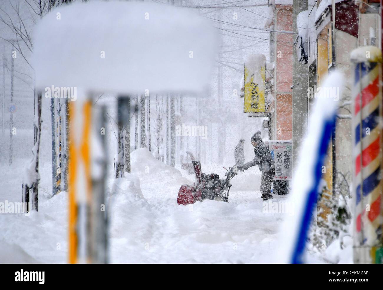 People remove snow in Fukagawa City, Hokkaido on November 19, 2024 ...