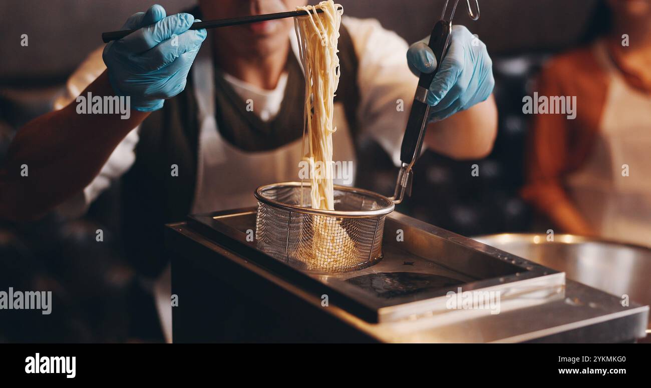 Japan, restaurant and hands cooking noodles for traditional cuisine, culinary culture and meal ...