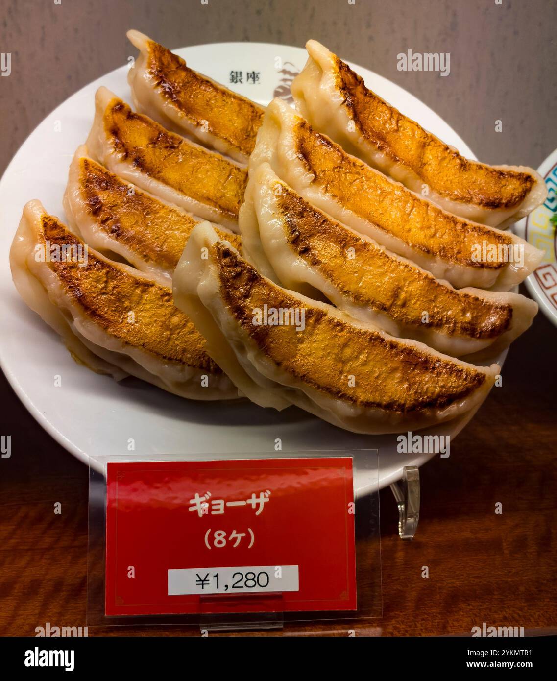 Heaping plate of eight goldenbrown gyoza, served in a japanese ...