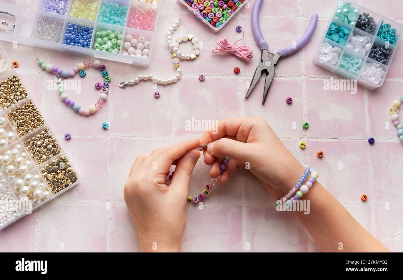 Kid creating handmade jewelry, enjoying a relaxing hobby Stock Photo ...