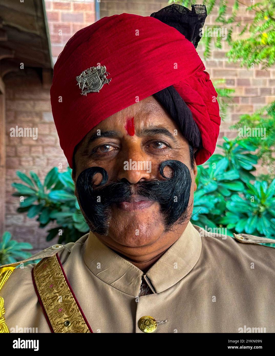 Closeup of an indian guard wearing a ceremonial outfit and a vibrant ...