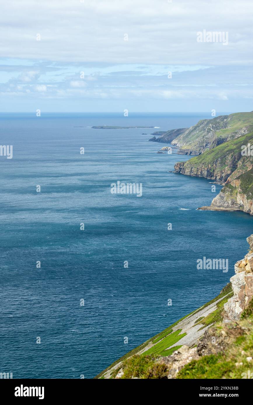 Vertical view of Slieve League cliffs in Ireland, showing steep rocky slopes meeting the deep ...