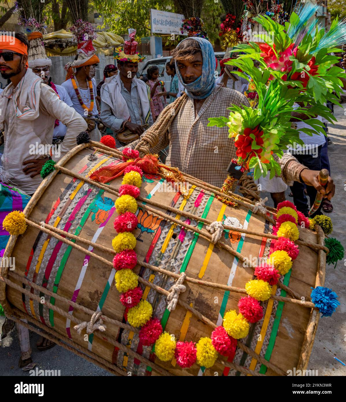 Colorful dressed musicians with large drum at a festive street event in ...