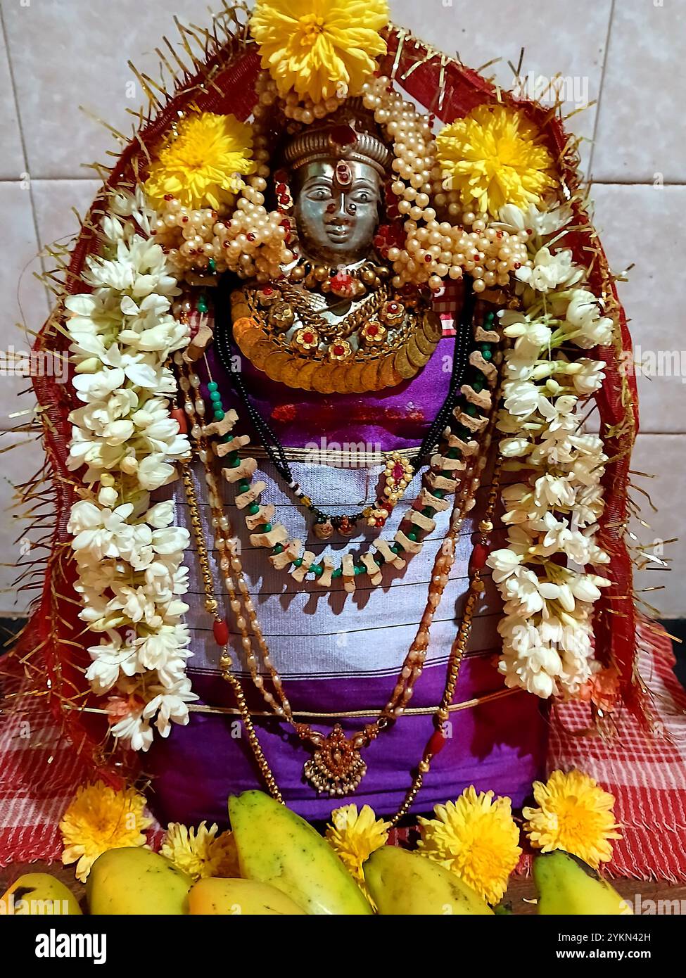 View Mahalakshmi idol profusely decorated with flowers, ornaments and ...