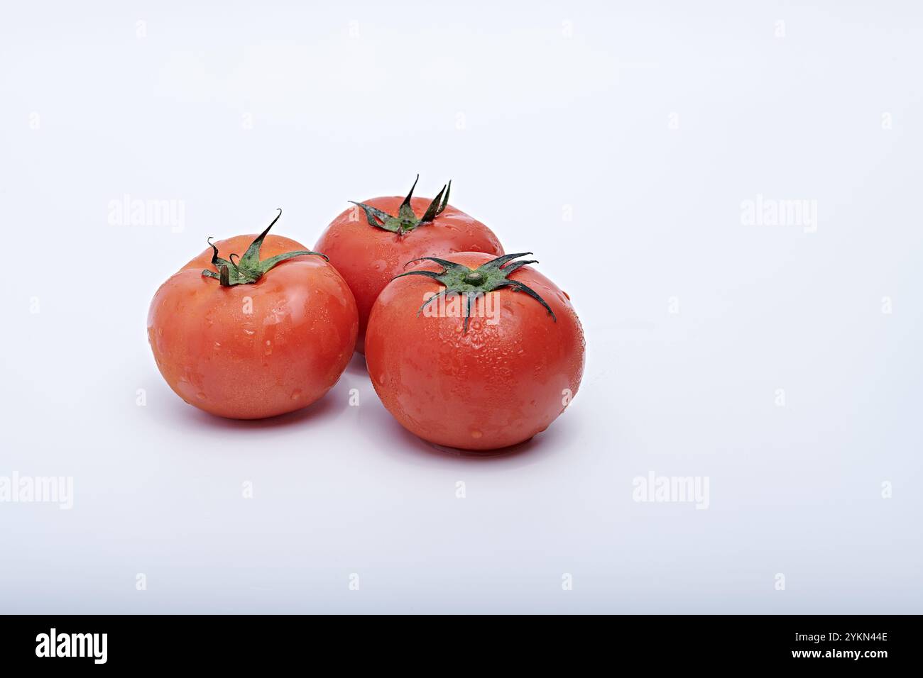 Healthy vegetable tomatoes photographed on a white background and base ...