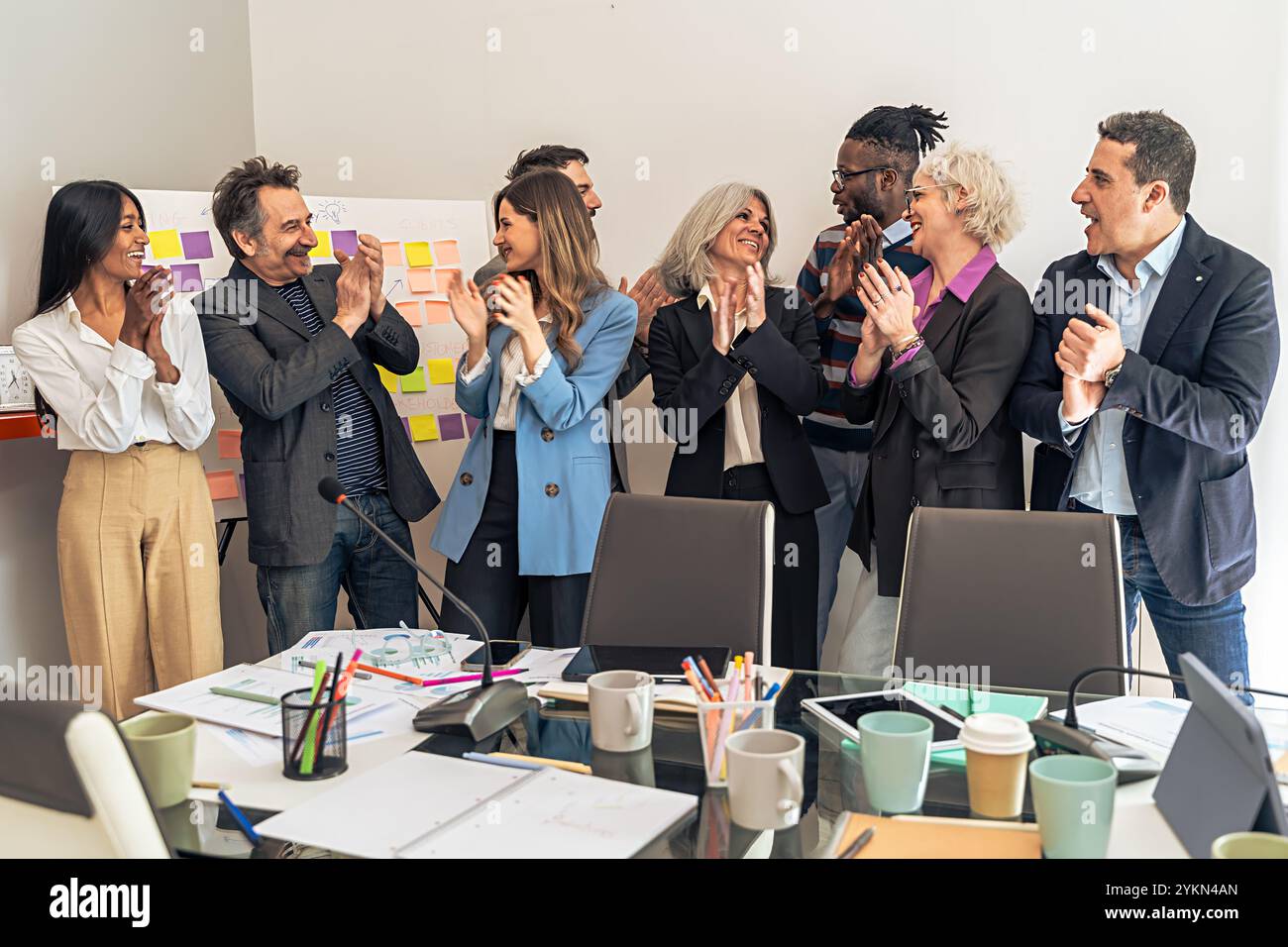 Joyful diverse business team sharing laughing moment during creative ...