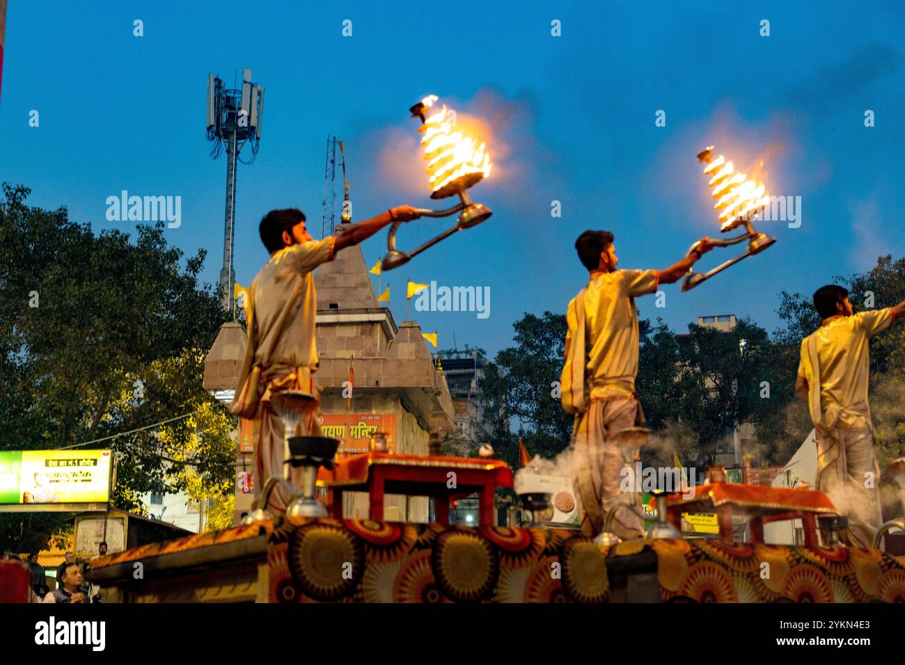 Devotees perform traditional fire aarti ceremony at dusk in an indian ...