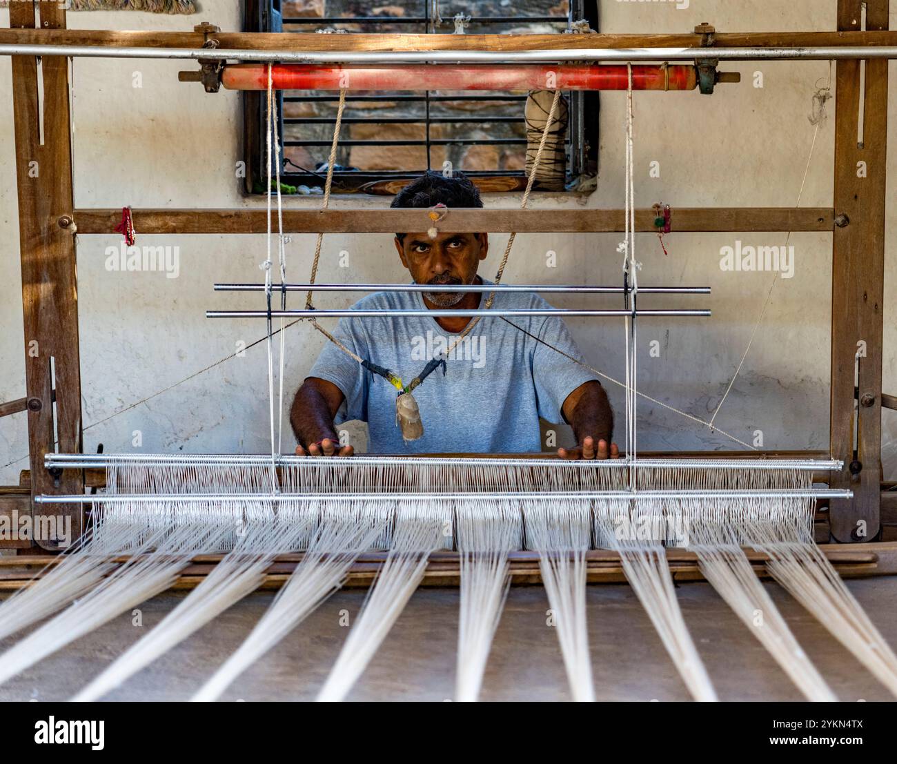 Focused craftsman works on a loom, creating textiles with skill Stock ...