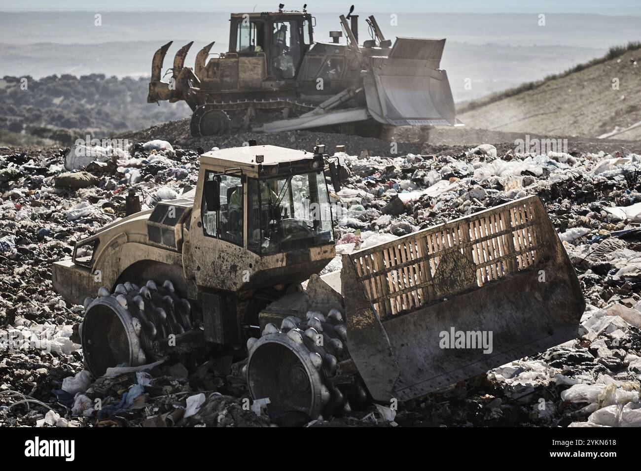 Heavy machinery shredding garbage in an open air landfill. Waste Stock ...