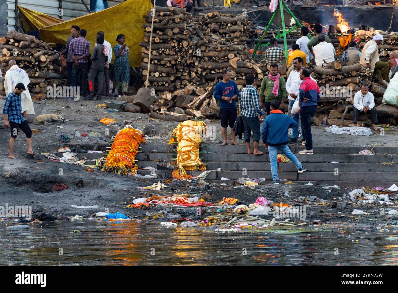 Group of people partaking in traditional funeral rites by the river ...