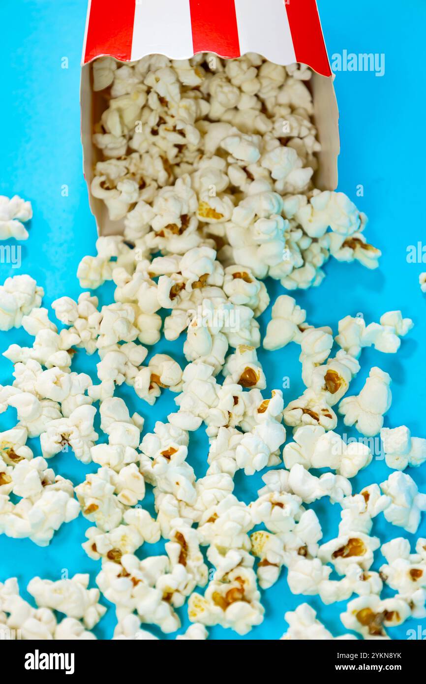 Vertical image of fallen red and white cardboard bucket scattering ...