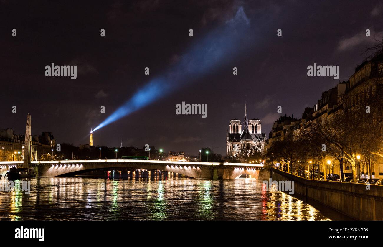 Paris at night, river Seine on the foreground, the Eiffel Tower and its ...