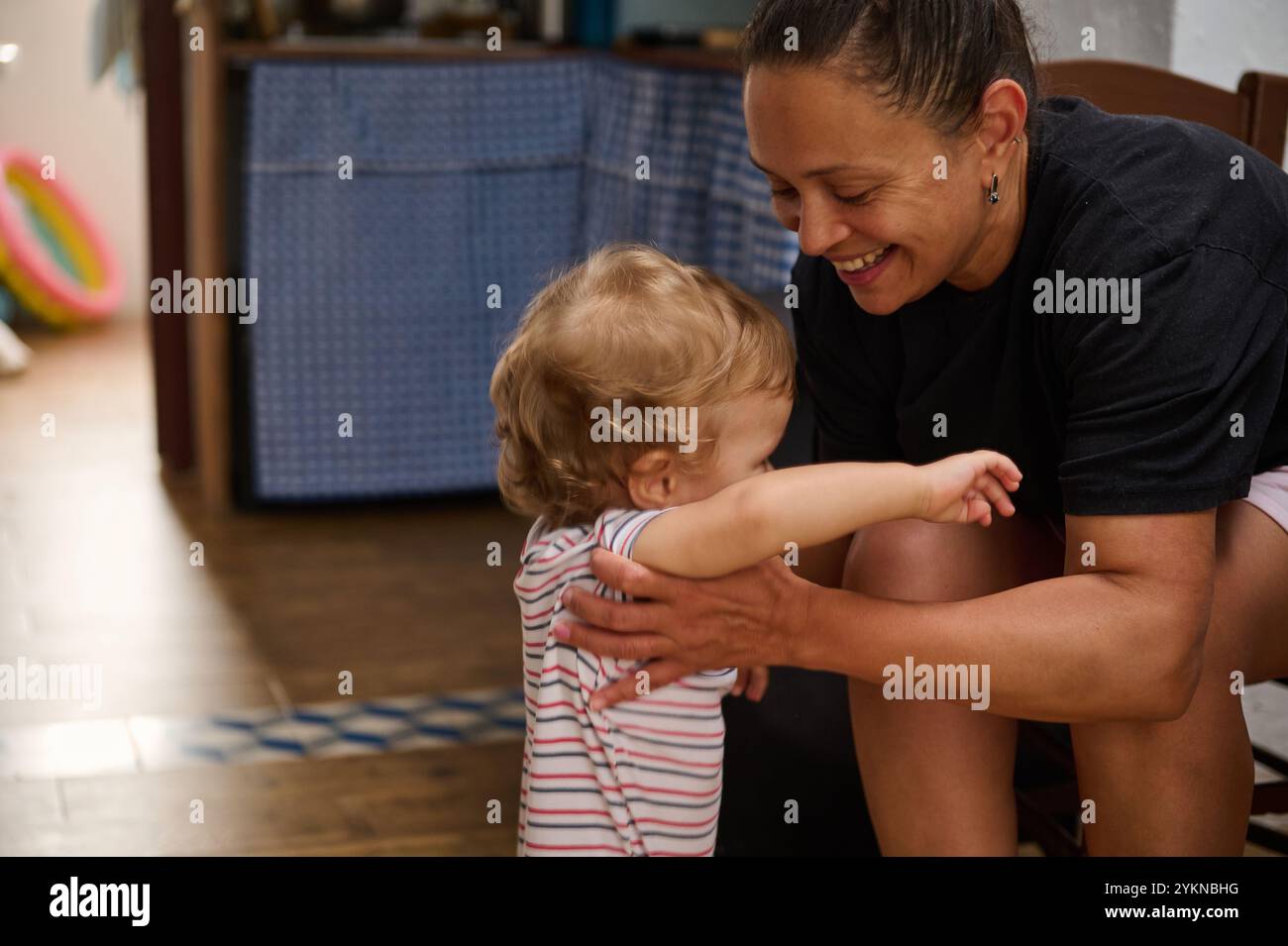A joyful moment of connection between a smiling caregiver and a happy ...