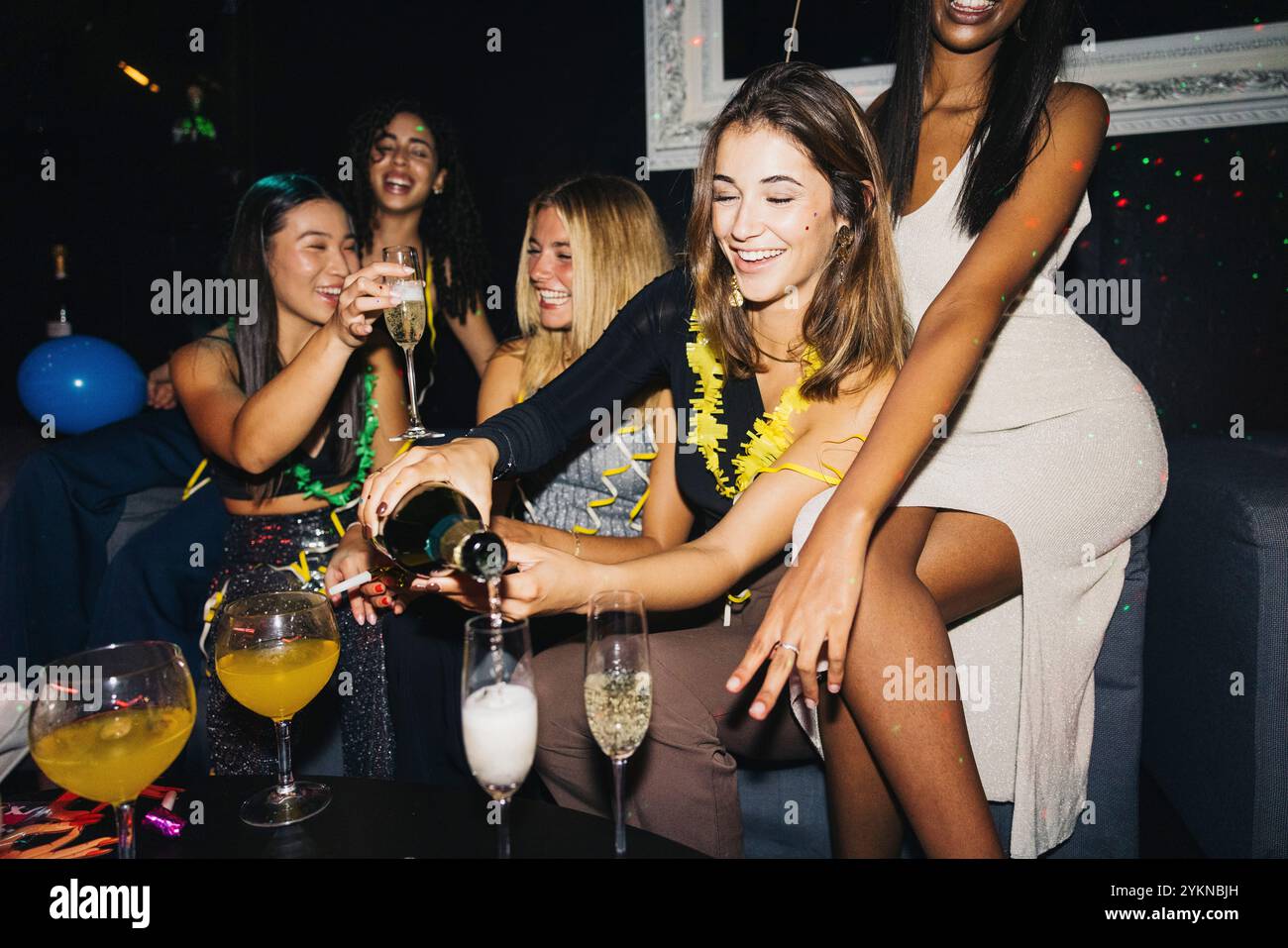 A lively group of young women enjoying a night out at a night club ...