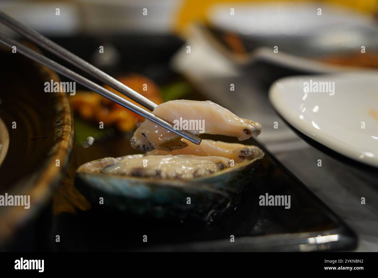 Eat fresh abalone sliced raw Stock Photo - Alamy