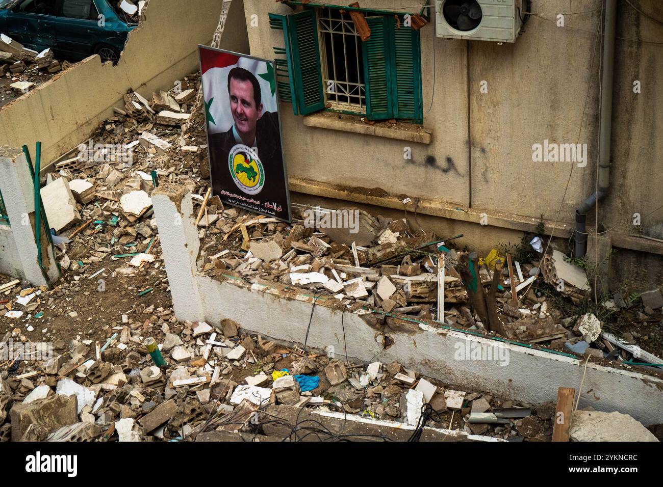 The portrait of Syrian president Bachar al-Assad sits on the rubble of ...