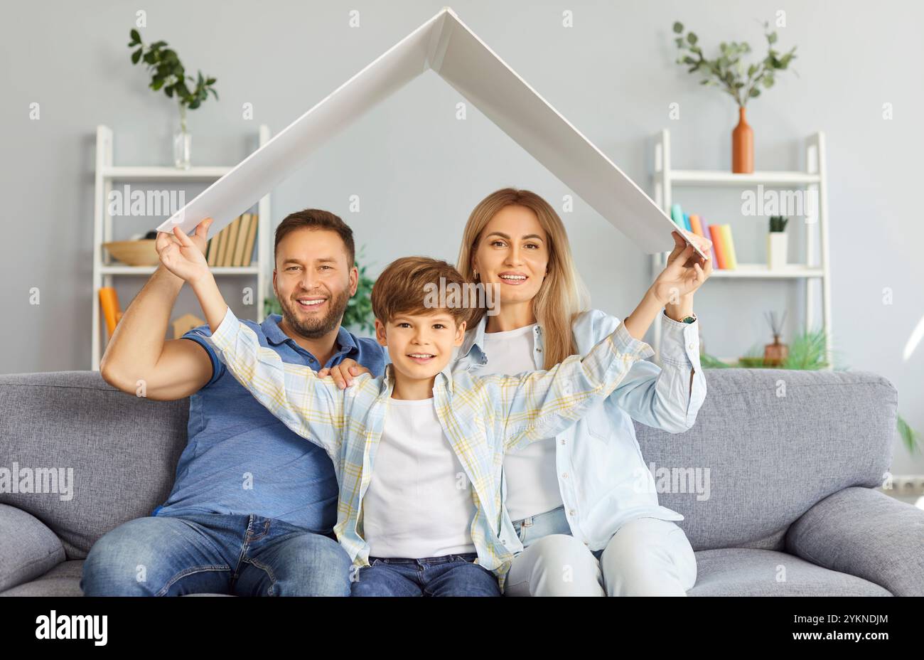 Portrait Of Happy Family Holding Roof Over Their Heads At Home Stock ...