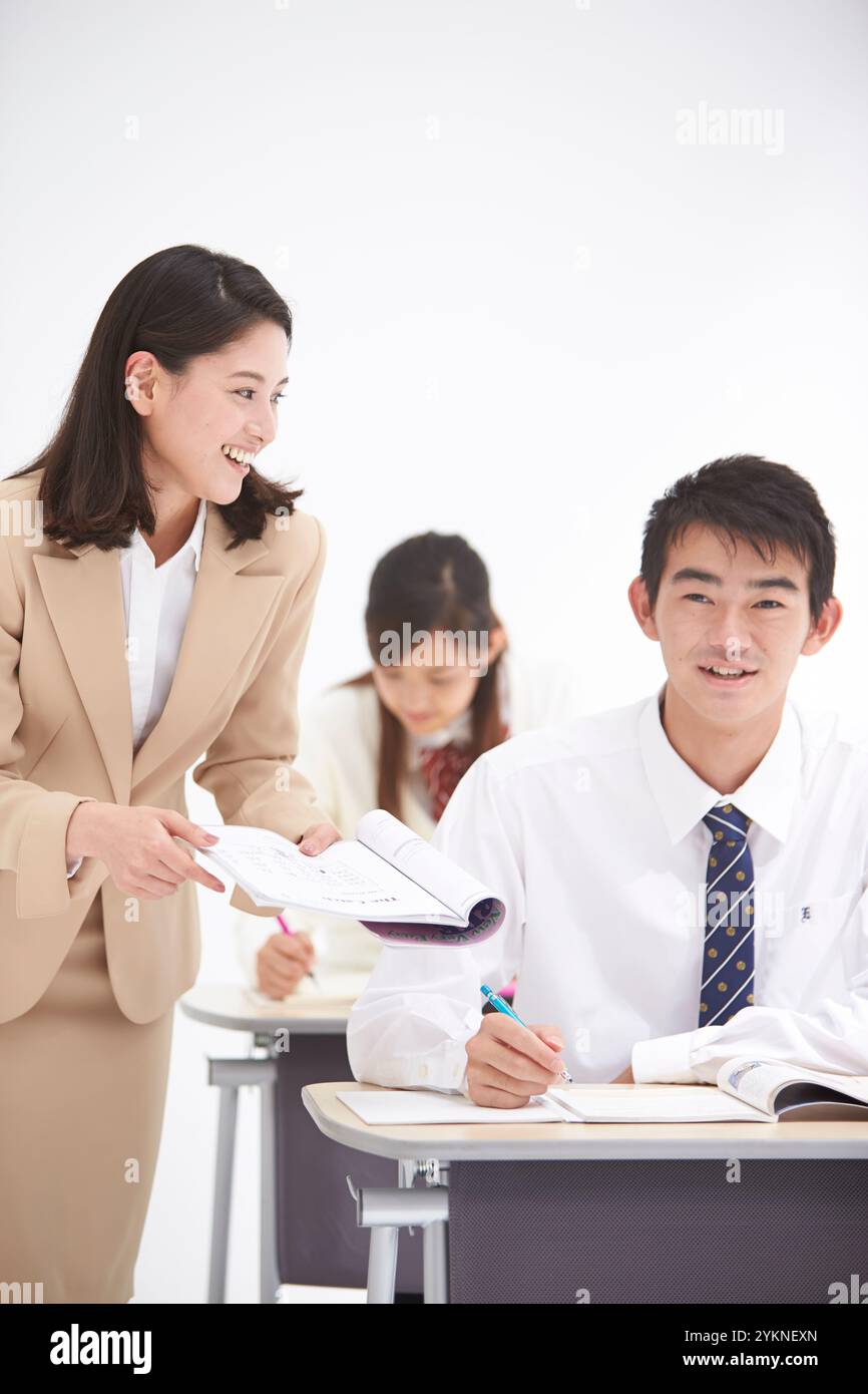 Female teacher and male and female high school pupils in class Stock ...