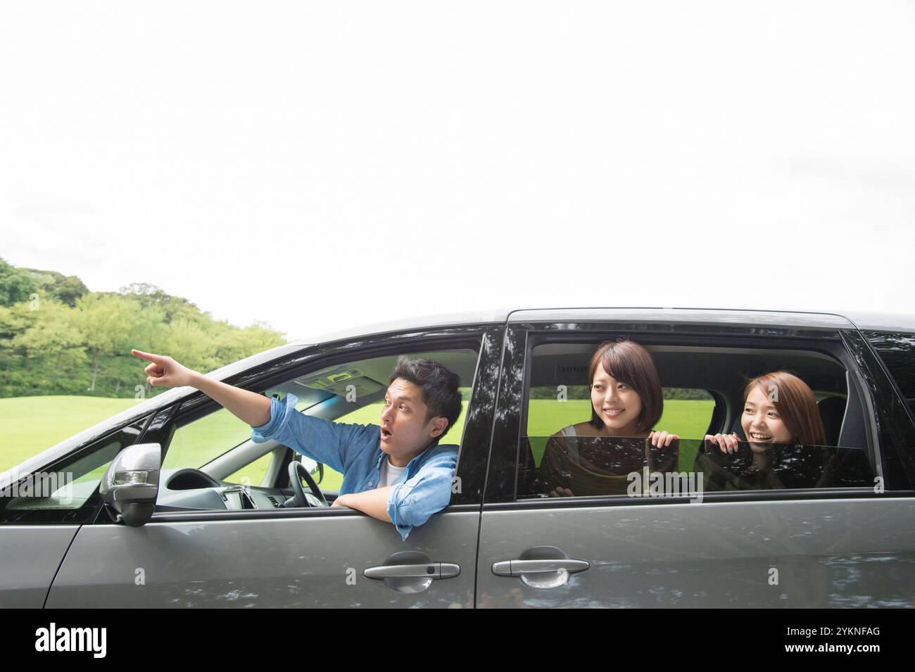 Three young people looking out of car Stock Photo - Alamy