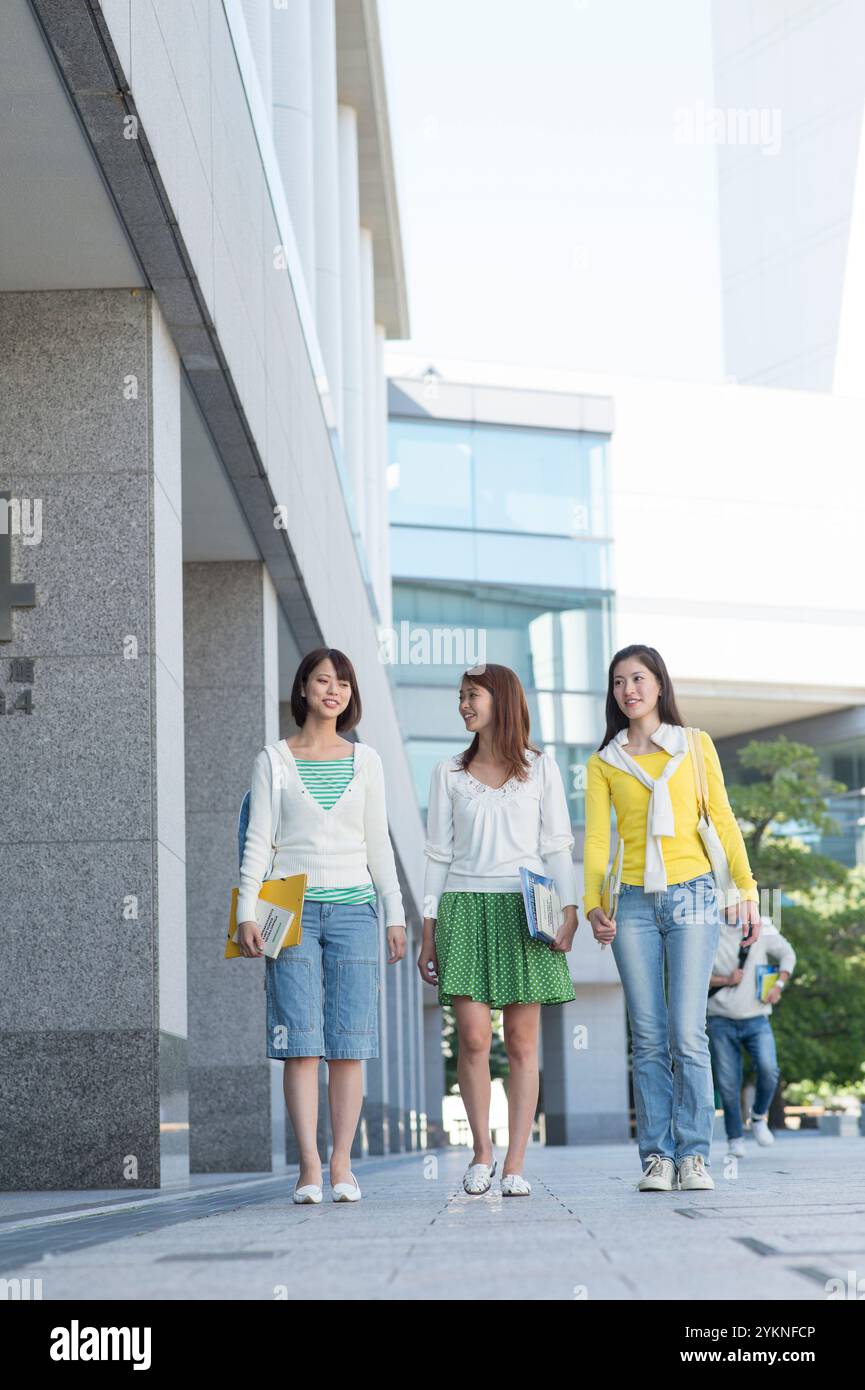 Three university students walking on campus Stock Photo - Alamy