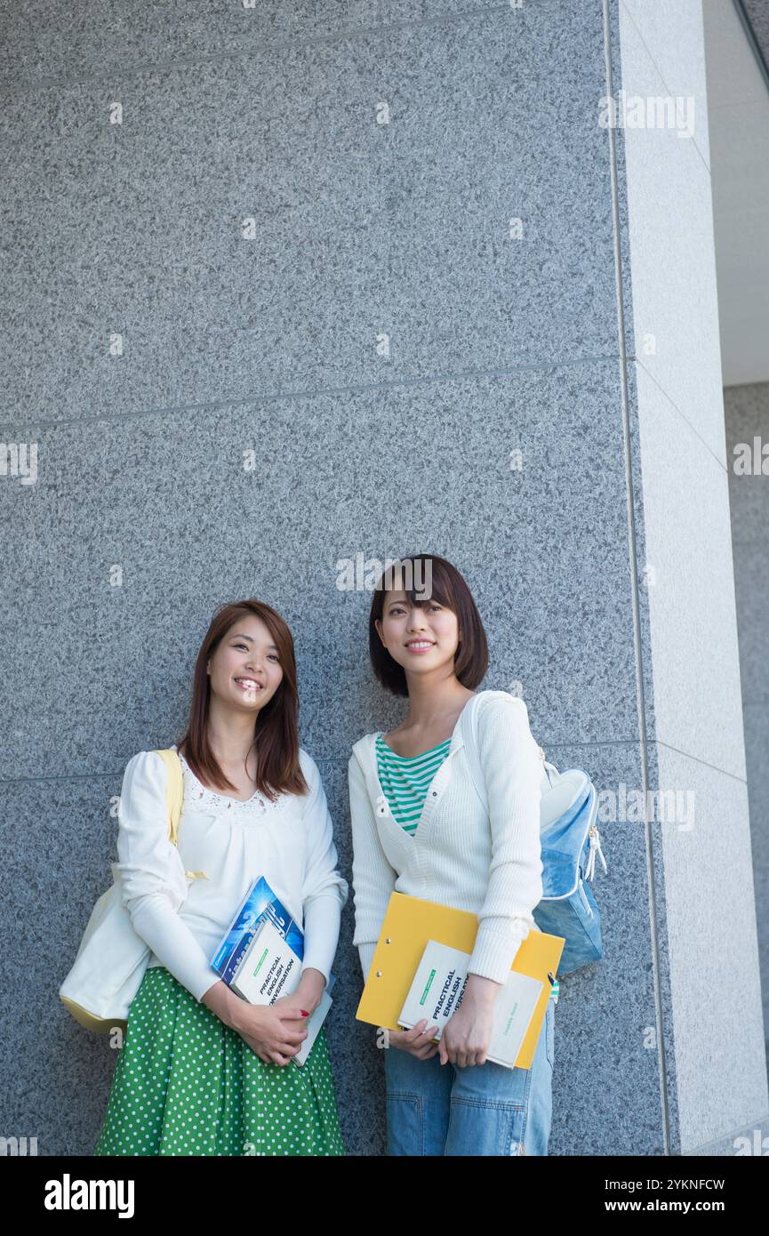 Two smiling female university students on campus Stock Photo - Alamy